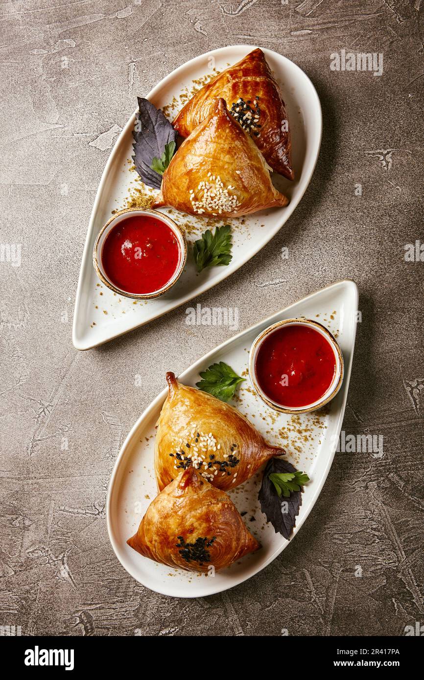 Samosa, samsa meat stuffed pies. Uzbek national dish samosa. Concept of Central Asian, South and ...