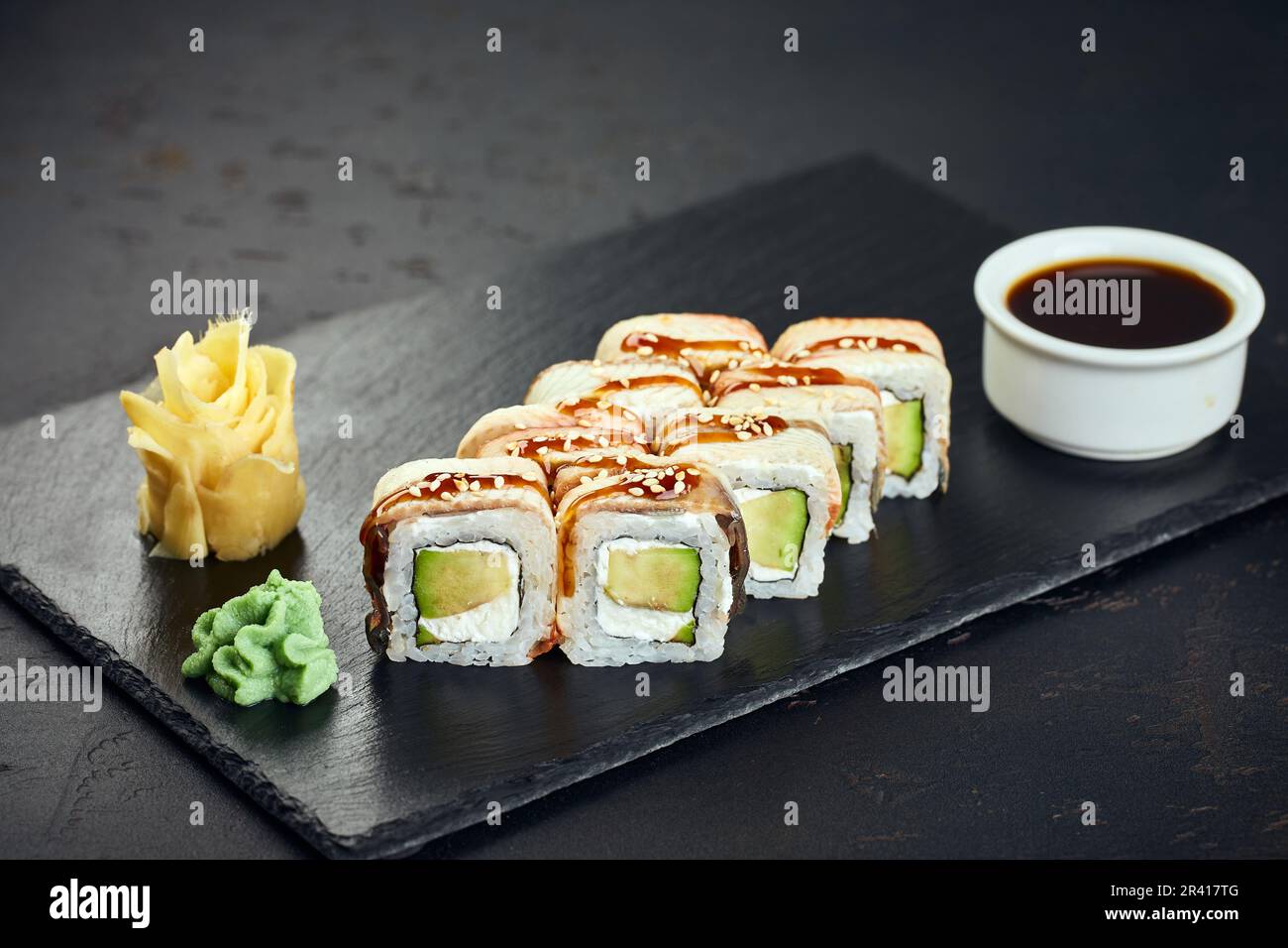 Sushi roll with eel, avocado, cream cheese on dark background. Sushi ...