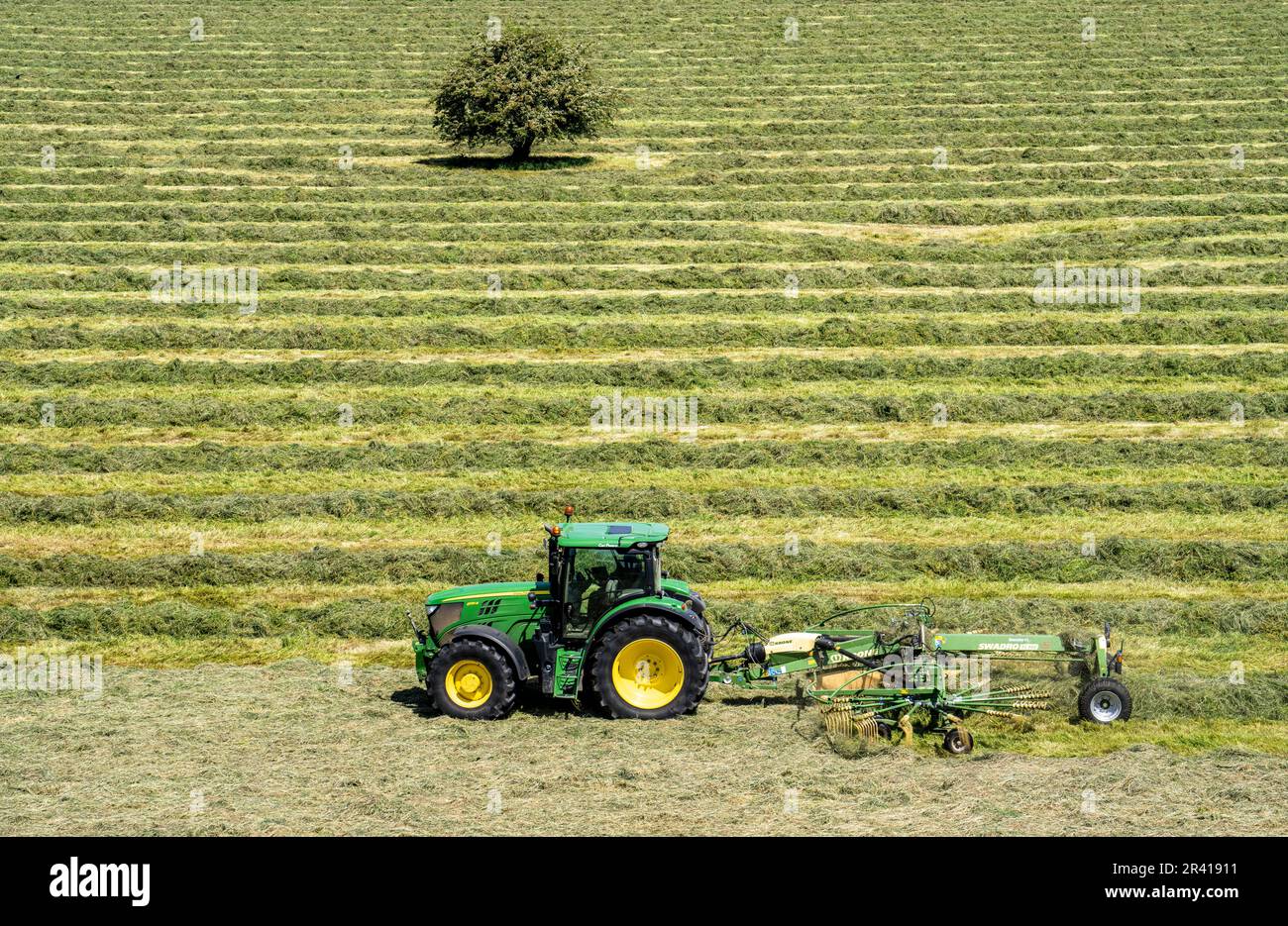 Tedder turning grass hi-res stock photography and images - Alamy