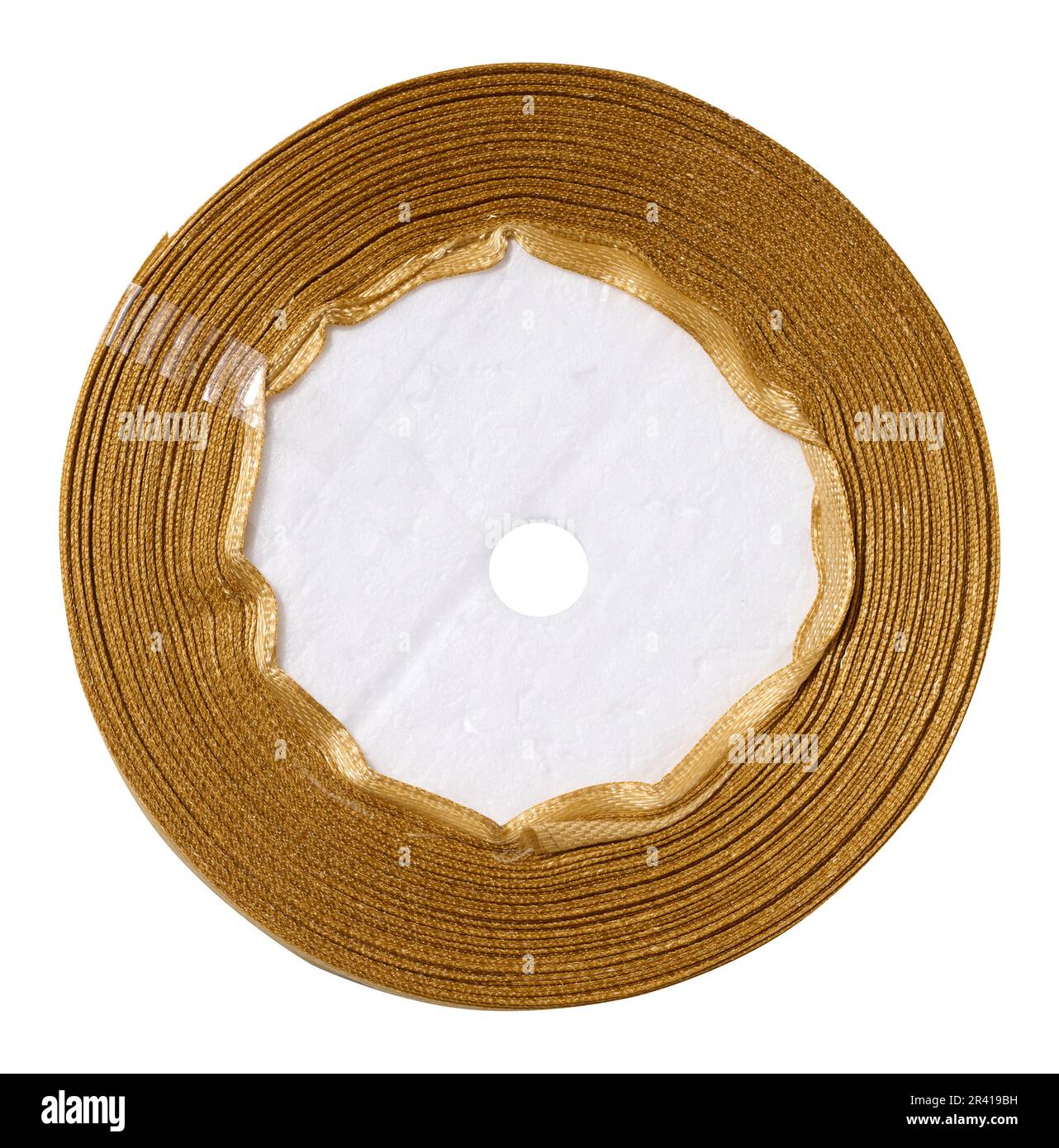 A spool with a golden silk ribbon on a white isolated background, an ...
