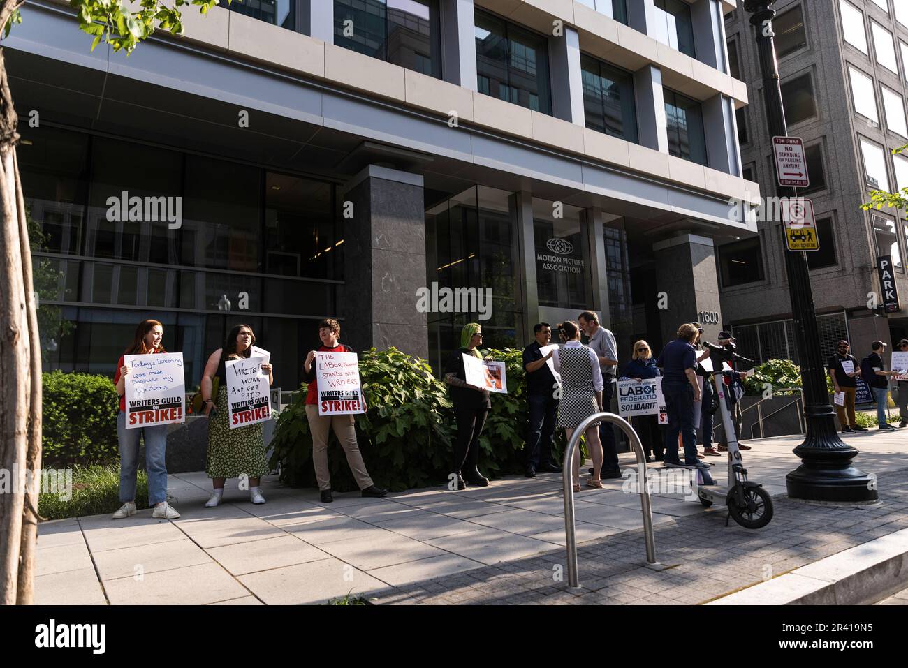 Washington DC, USA. 24th May, 2023. Protesters hold signs expressing ...