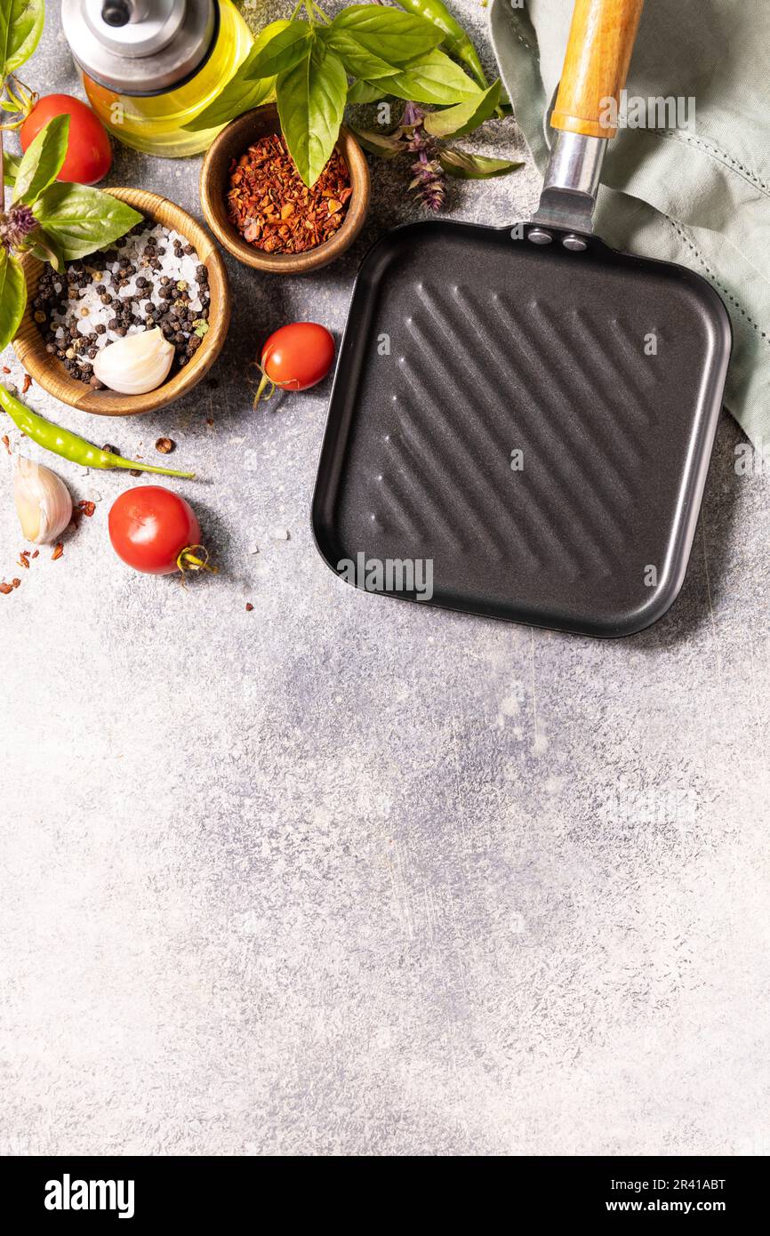 Food cooking background on gray background with grill pan. Empty grill ...