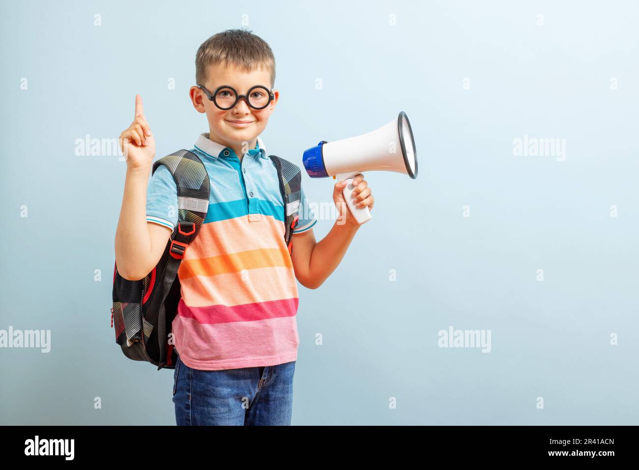 Little schoolboy with megaphone on blue background. Boy with megaphone ...