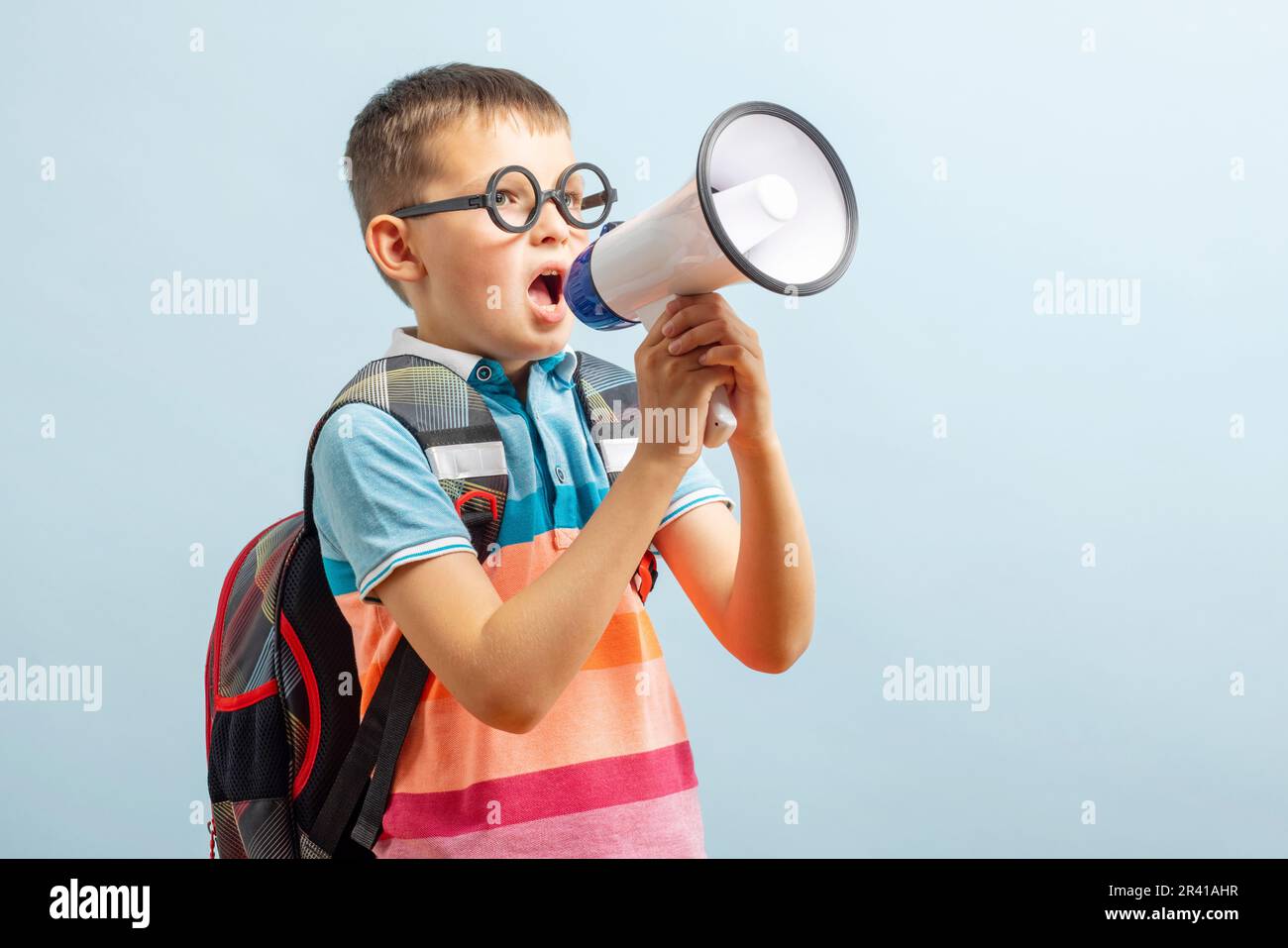 Little schoolboy with megaphone on blue background. Boy with megaphone ...