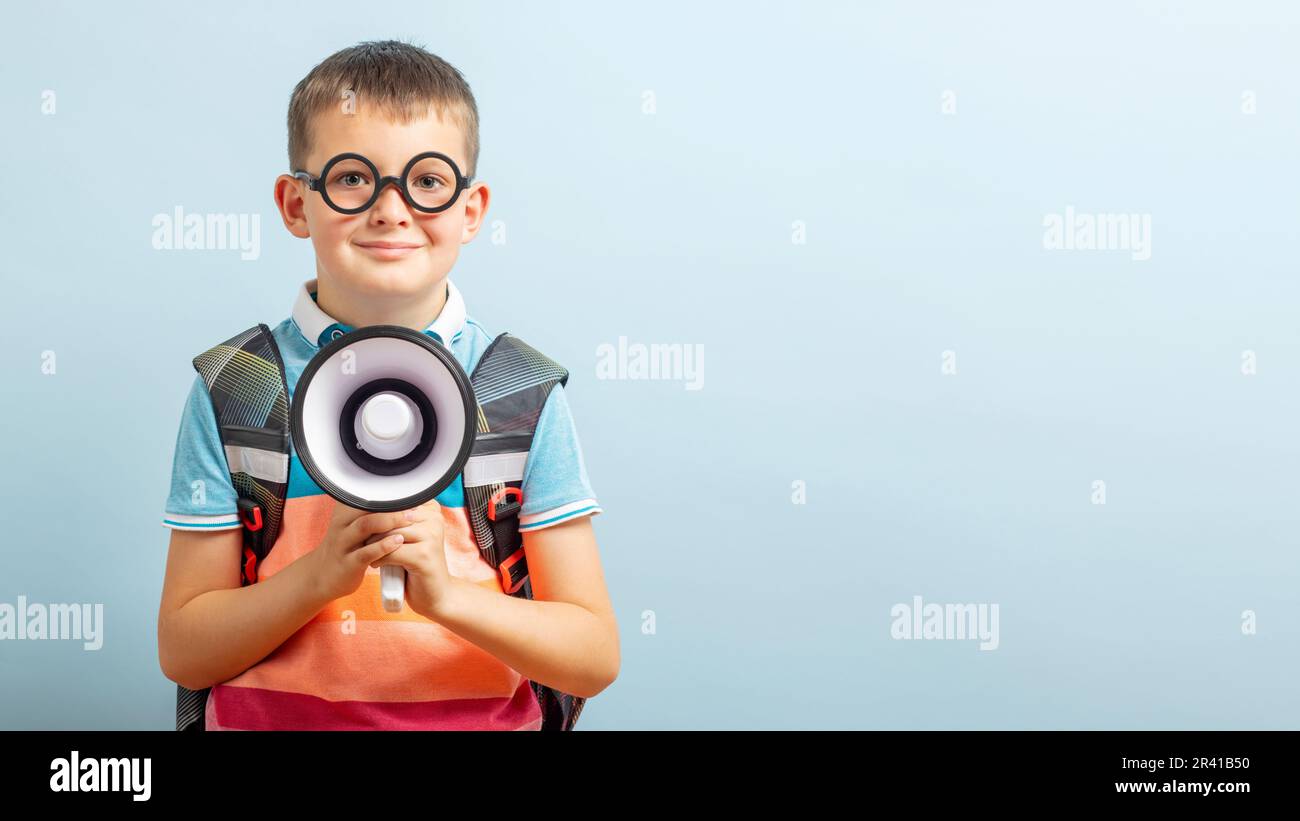 Little schoolboy with megaphone on blue background. Boy with megaphone ...