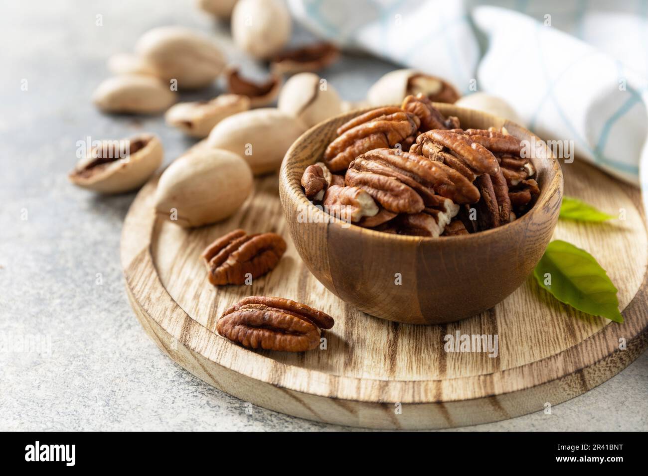 Bowl with pecan nuts on a stone table. Nuts and seeds, healthy fats ...