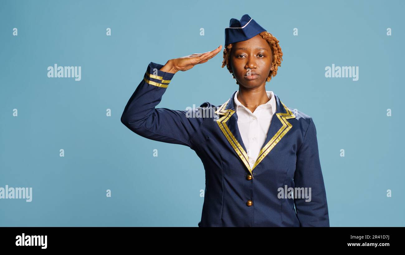 Female aircrew member doing military salute in studio Stock Photo - Alamy