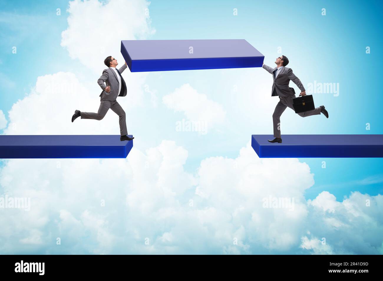 Concept of teamwork with bridge being built Stock Photo - Alamy