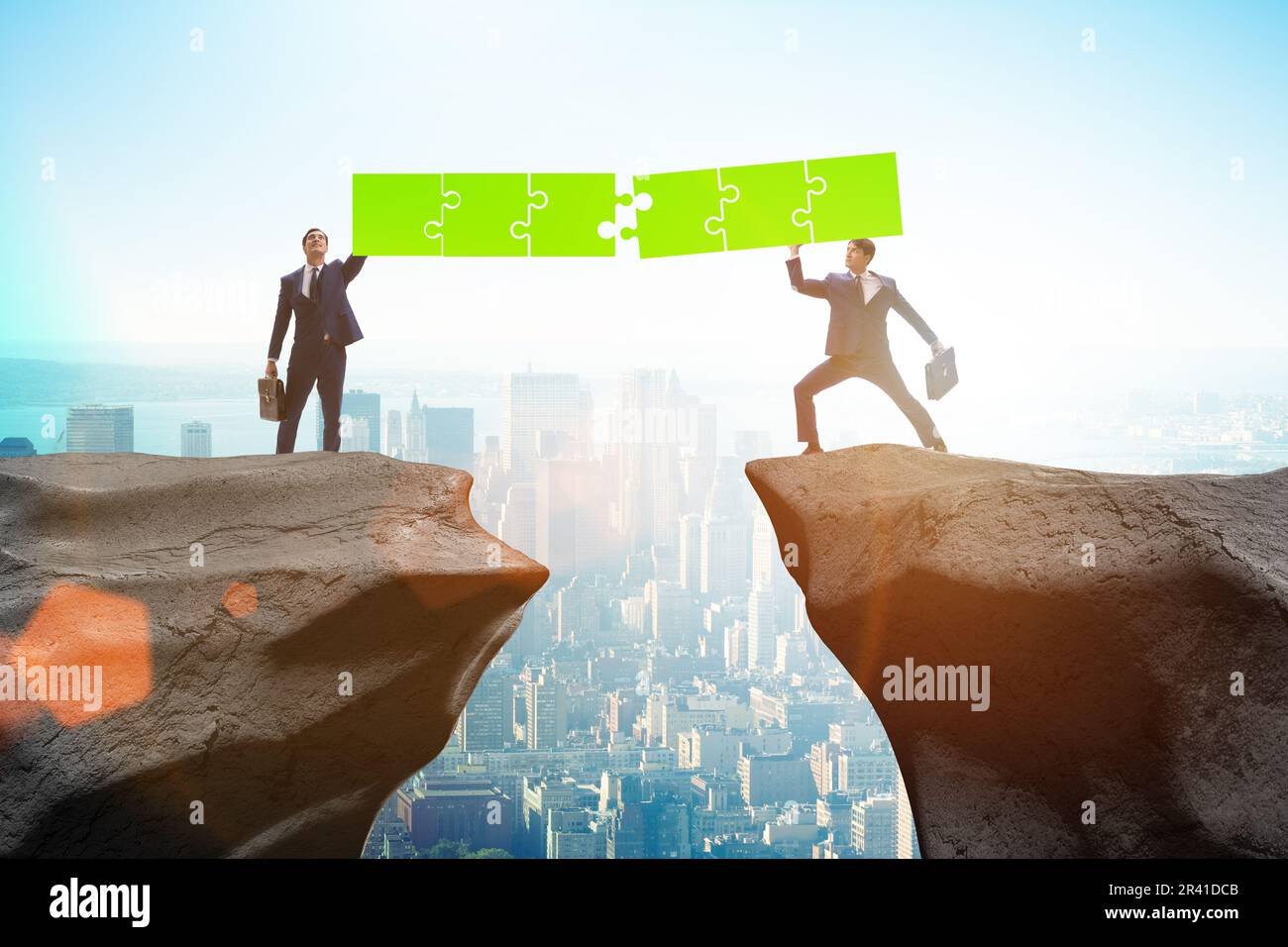 Concept of teamwork with bridge being built Stock Photo - Alamy