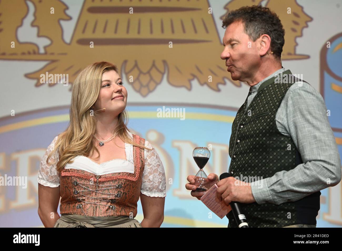 Munich, Germany. 25th May, 2023. Candidate Anna Eberle stands on stage with presenter Roman ...