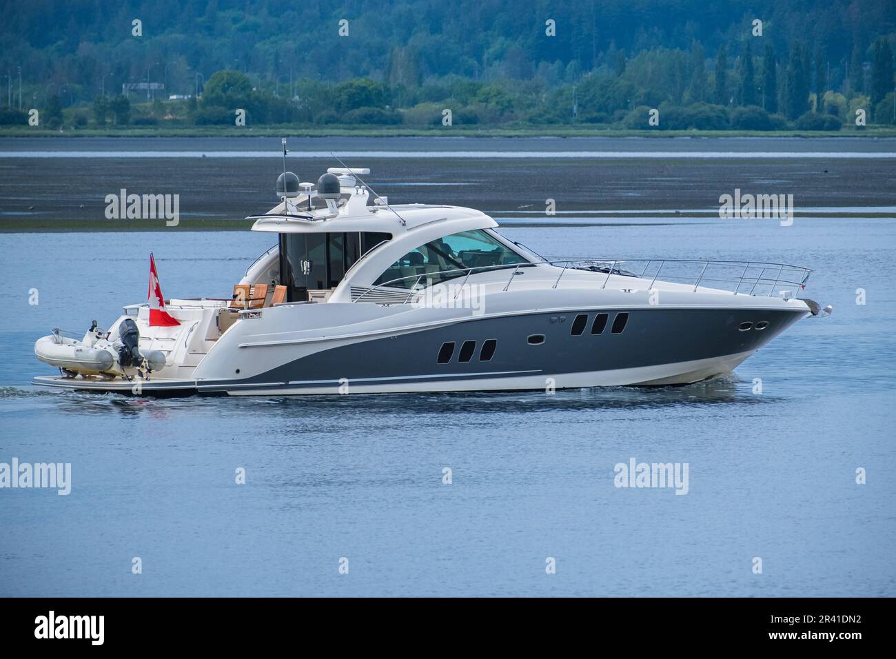 Luxury motor yacht in navigation. White and blue luxury yacht in motion ...