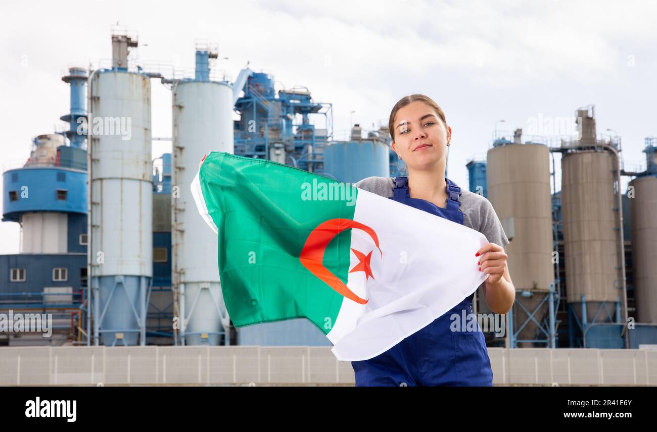 Concentrated young woman holds the national flag of Algeria Stock Photo ...