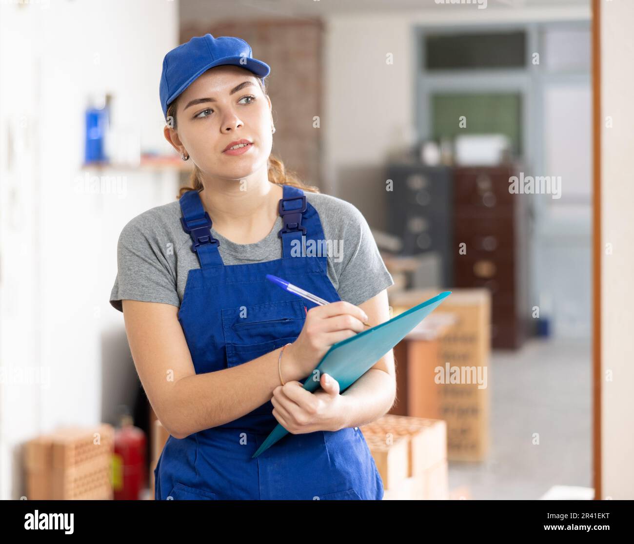 Woman architect taking notes on construction site Stock Photo - Alamy