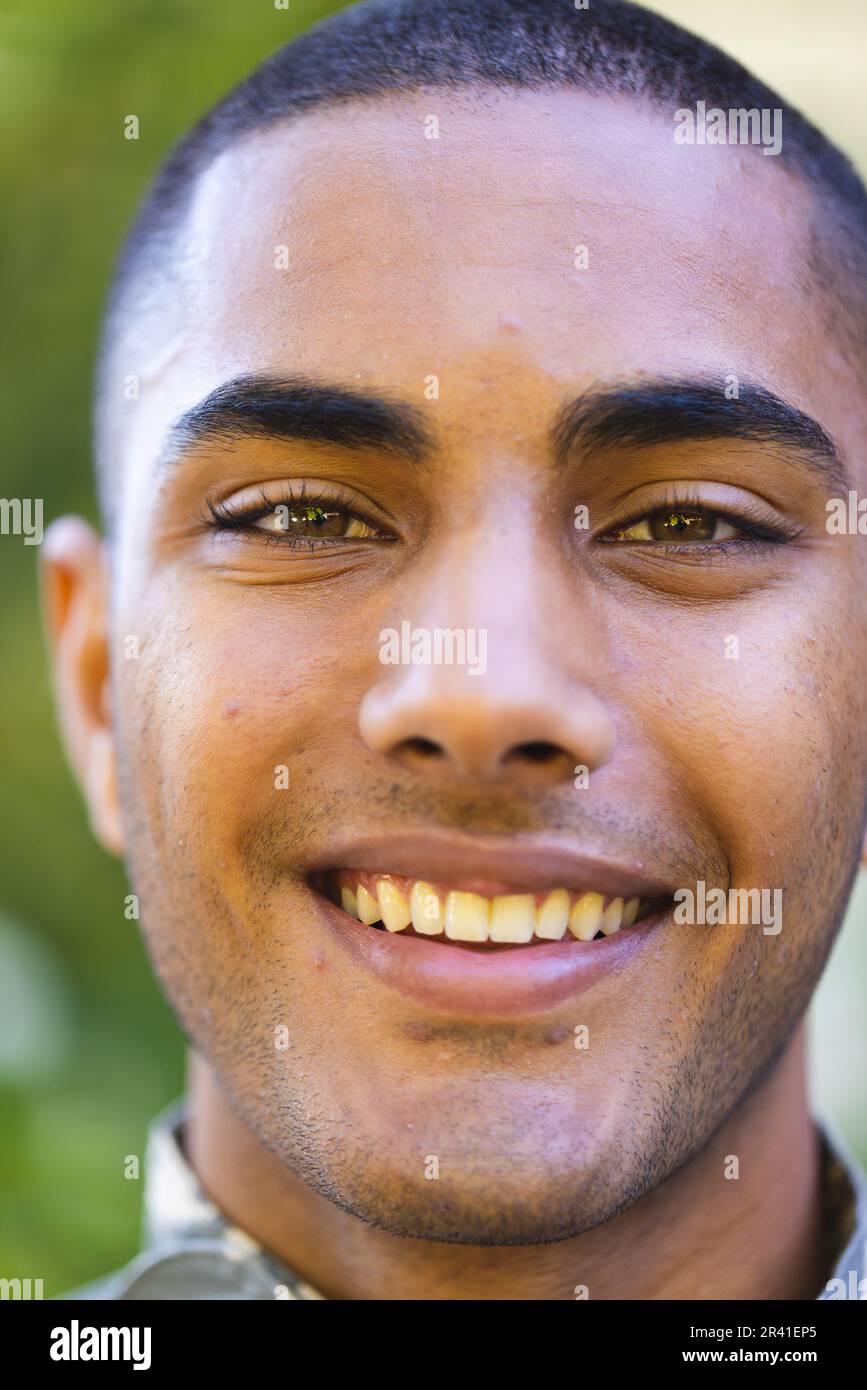 Portrait of happy biracial male soldier wearing military uniform ...