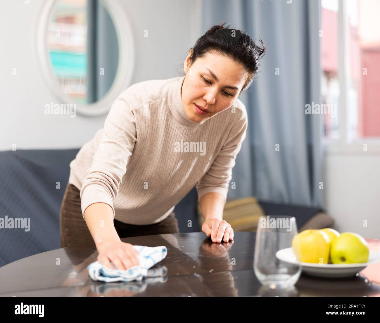 Woman washing table during cleanup Stock Photo - Alamy