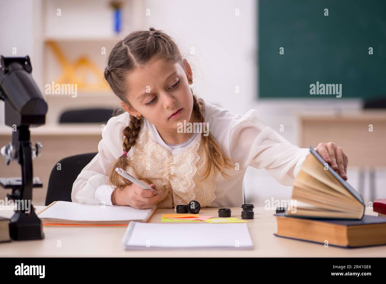 Small girl studying in the classroom Stock Photo - Alamy