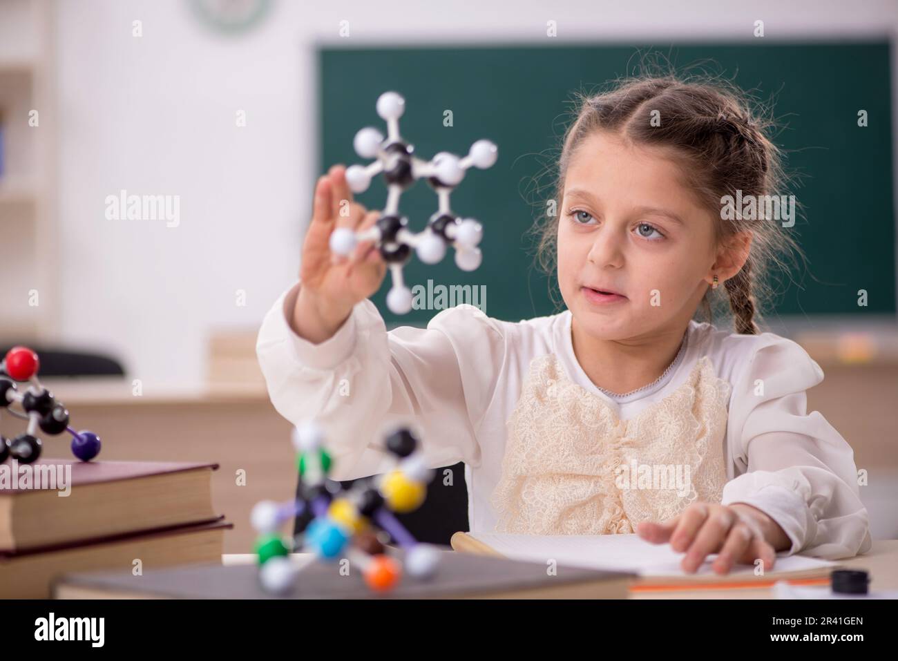 Small girl studying in the classroom Stock Photo - Alamy