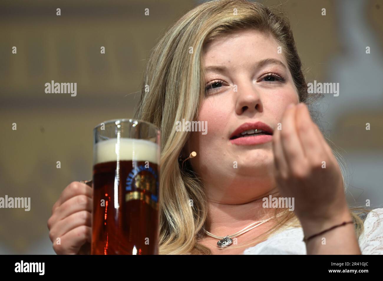 Munich, Germany. 25th May, 2023. Candidate Anna Eberle talks about a beer on stage at the ...