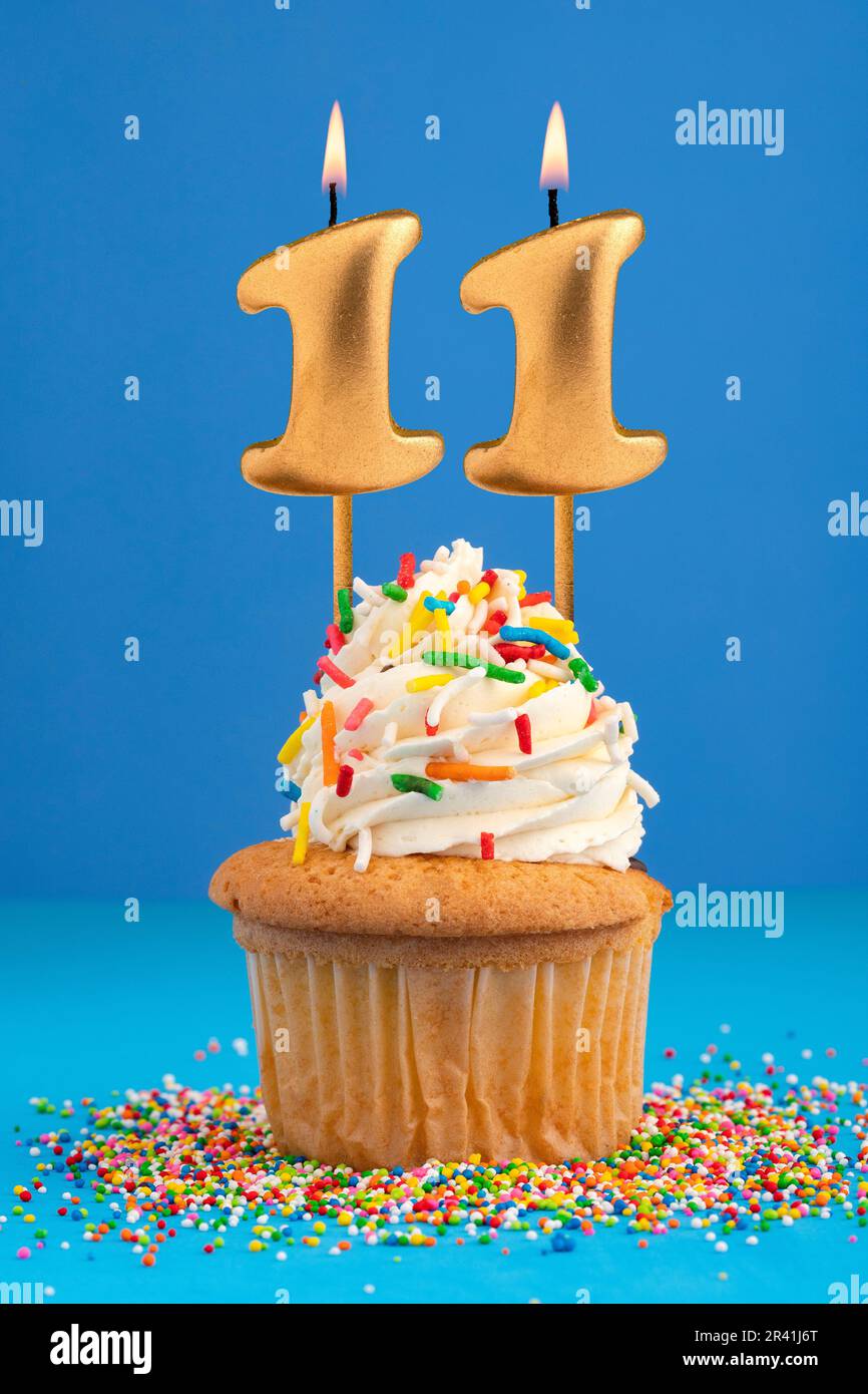Candle number 11 - Cake birthday in blue background Stock Photo - Alamy