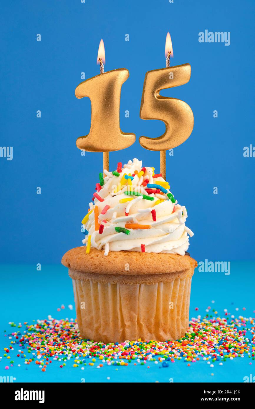 Candle number 15 - Cake birthday in blue background Stock Photo - Alamy