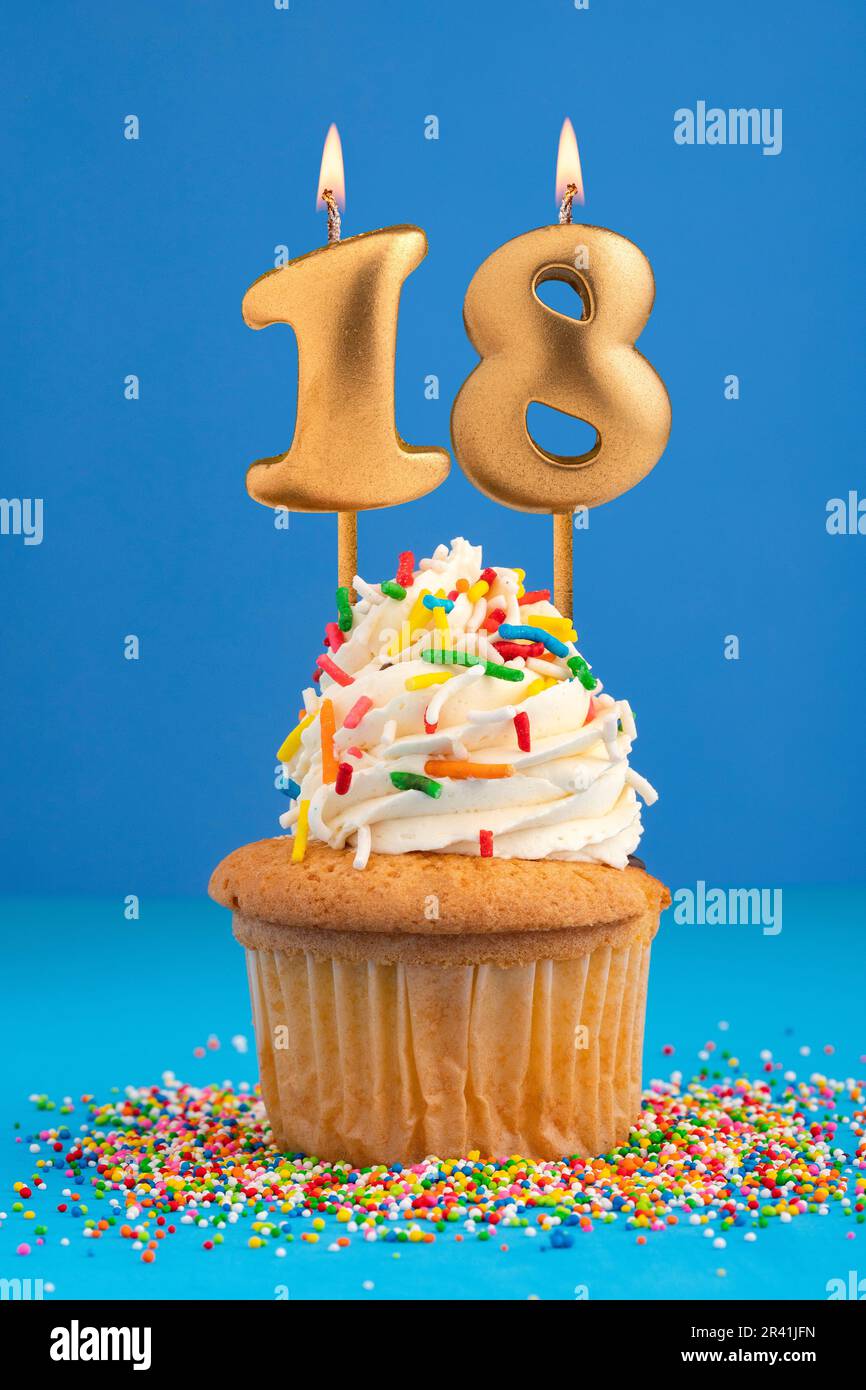 Birthday cake with candle number 18 - Blue background Stock Photo - Alamy