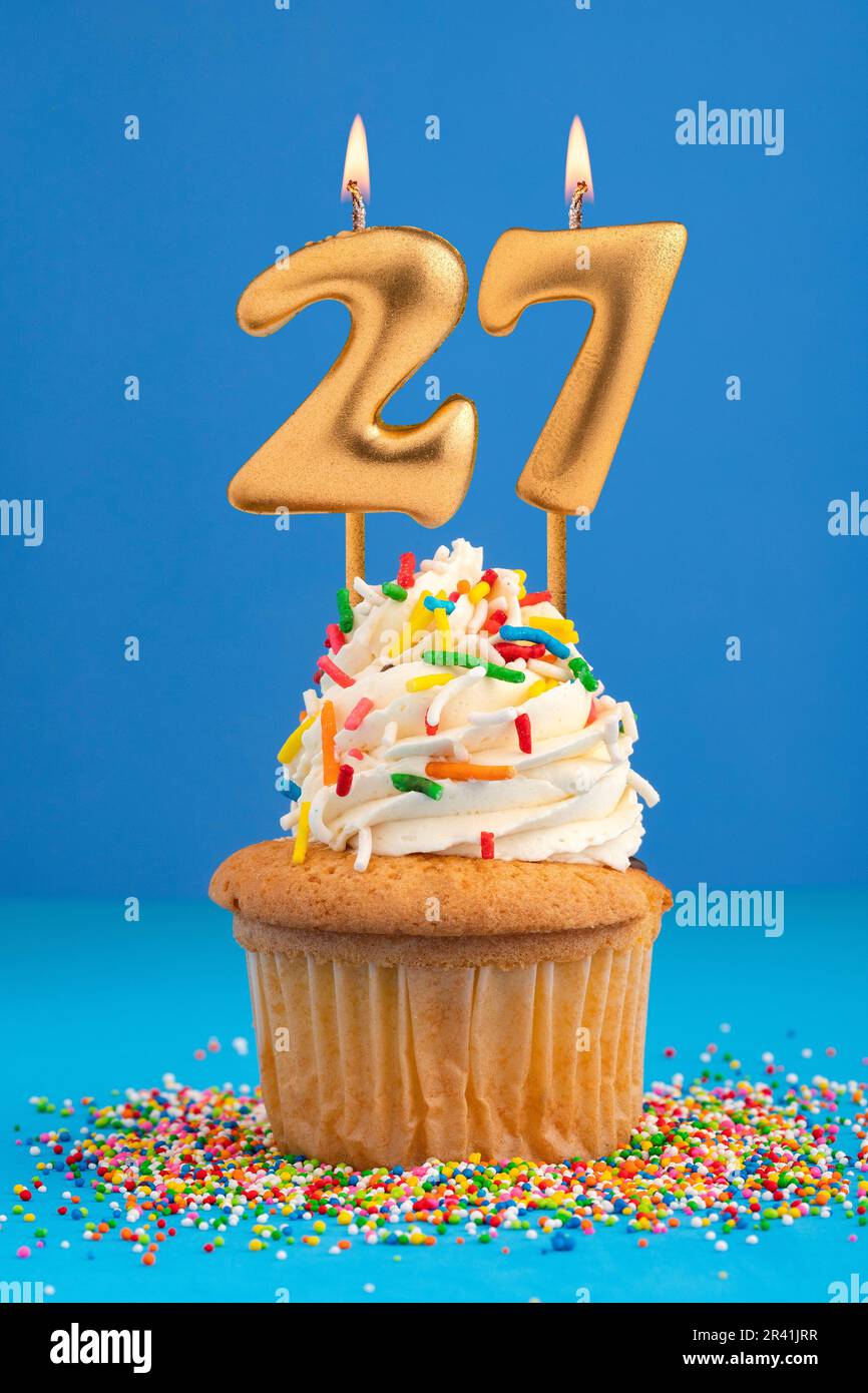 Candle number 27 - Cake birthday in blue background Stock Photo - Alamy