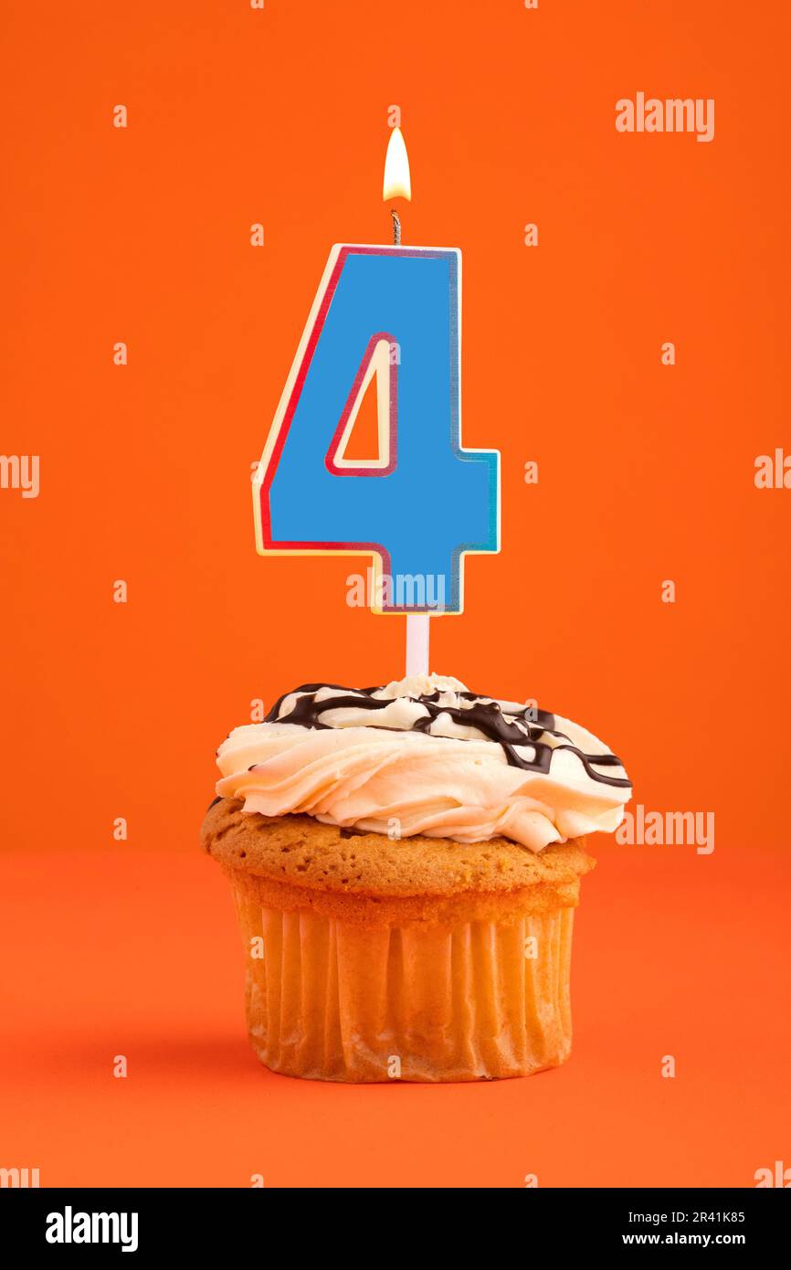 Birthday cake with number 4 blue candle - orange background Stock Photo ...