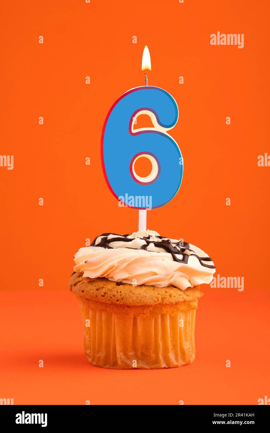 Birthday cake with number 6 blue candle - orange background Stock Photo ...