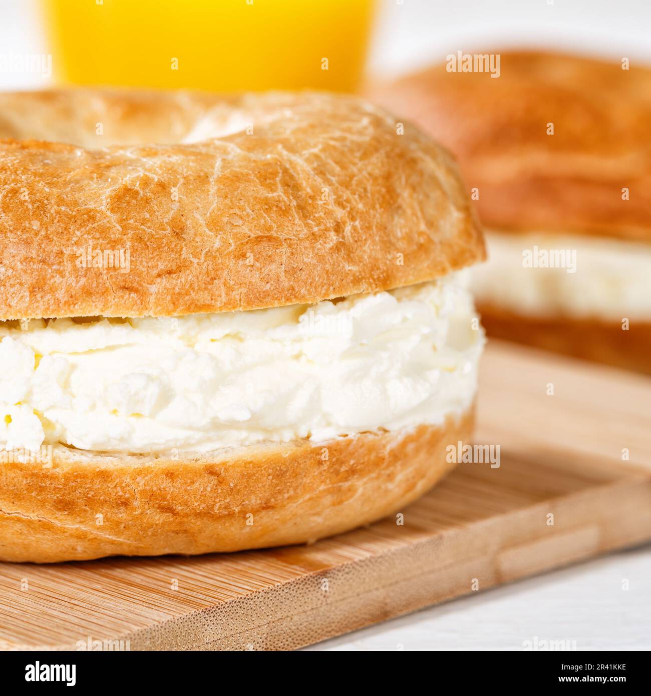 Bagel roll sandwich for breakfast topped with cream cheese close up ...