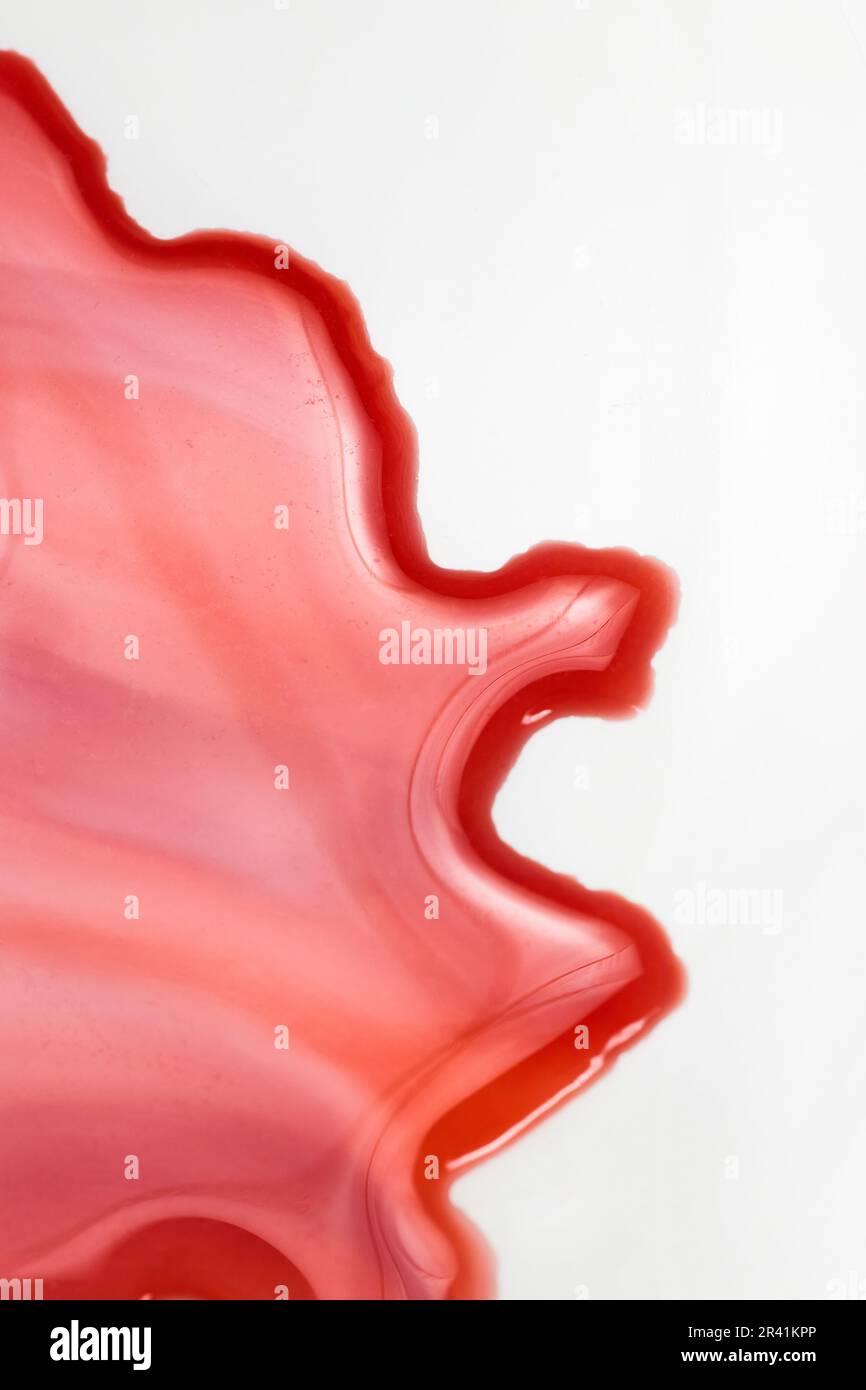 Abstract pool of red blood on vertical white background from red ...