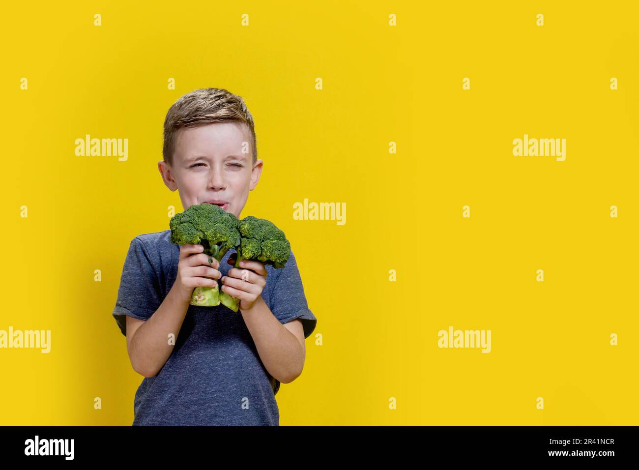 A charming little boy refusing to eat broccoli. Brootish broccoli Stock ...