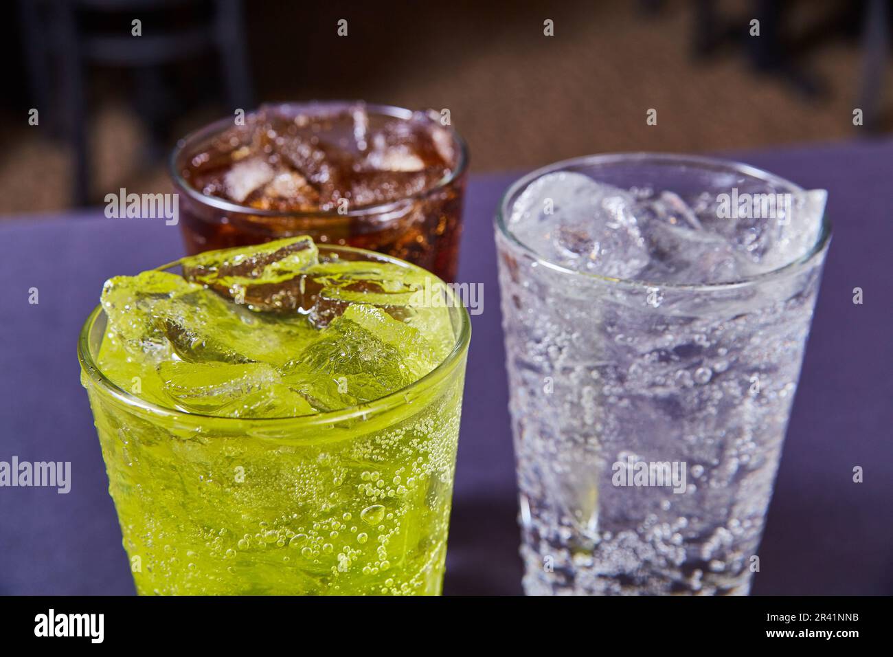 Three Coke or Pepsi soft drinks dark brown, lime green, clear bubbly soda beverages Stock Photo ...
