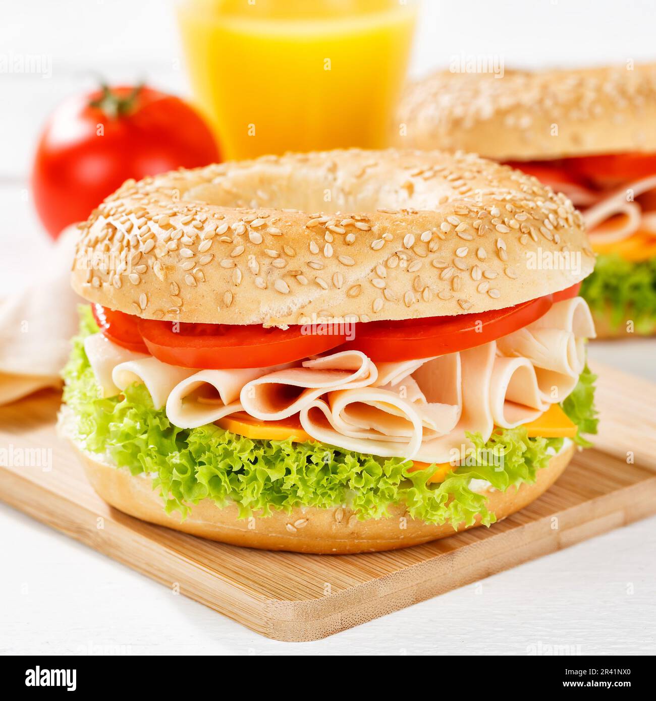 Bagel sandwich for breakfast topped with chicken ham square in ...