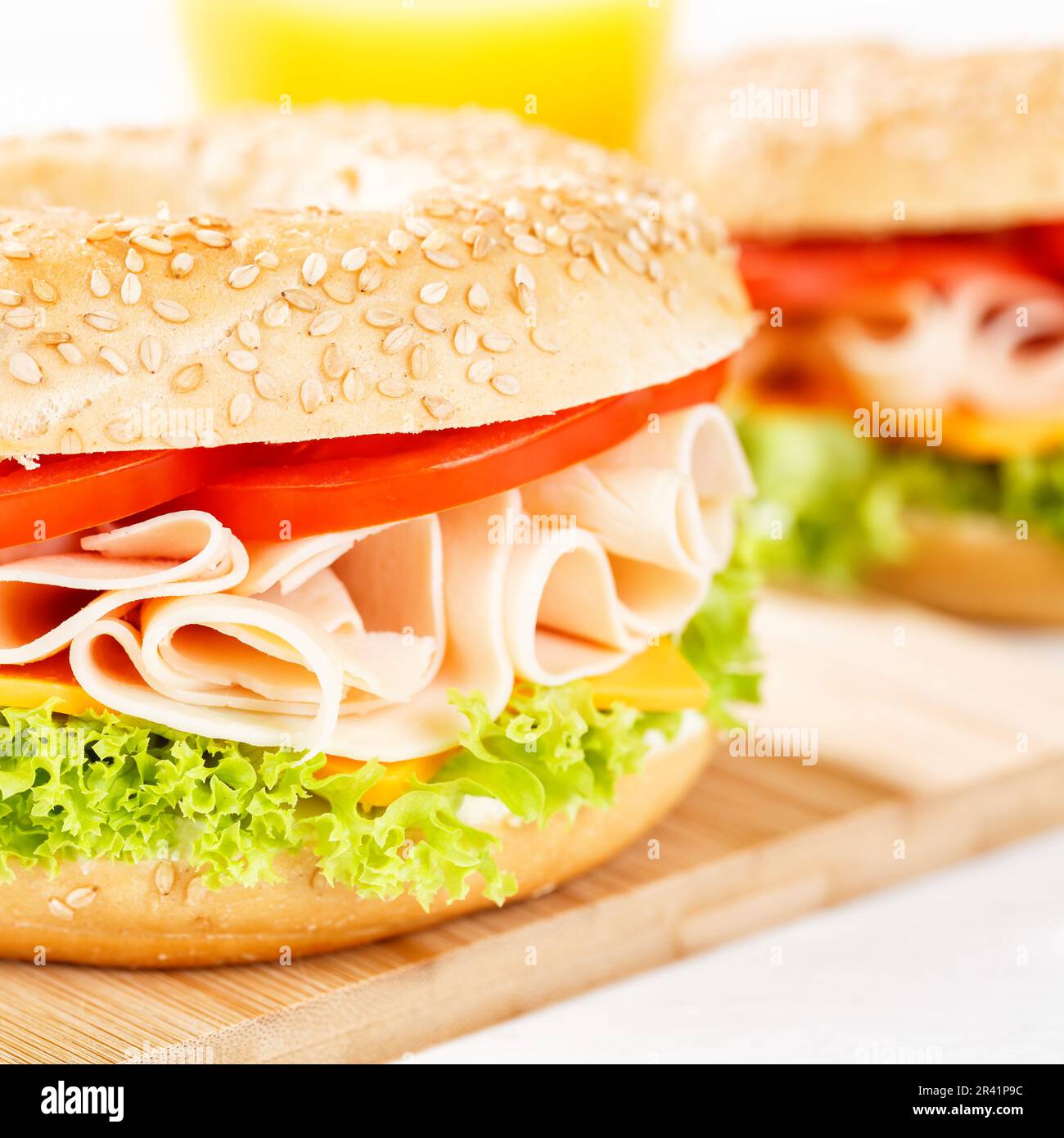 Bagel roll sandwich for breakfast topped with chicken ham close up ...