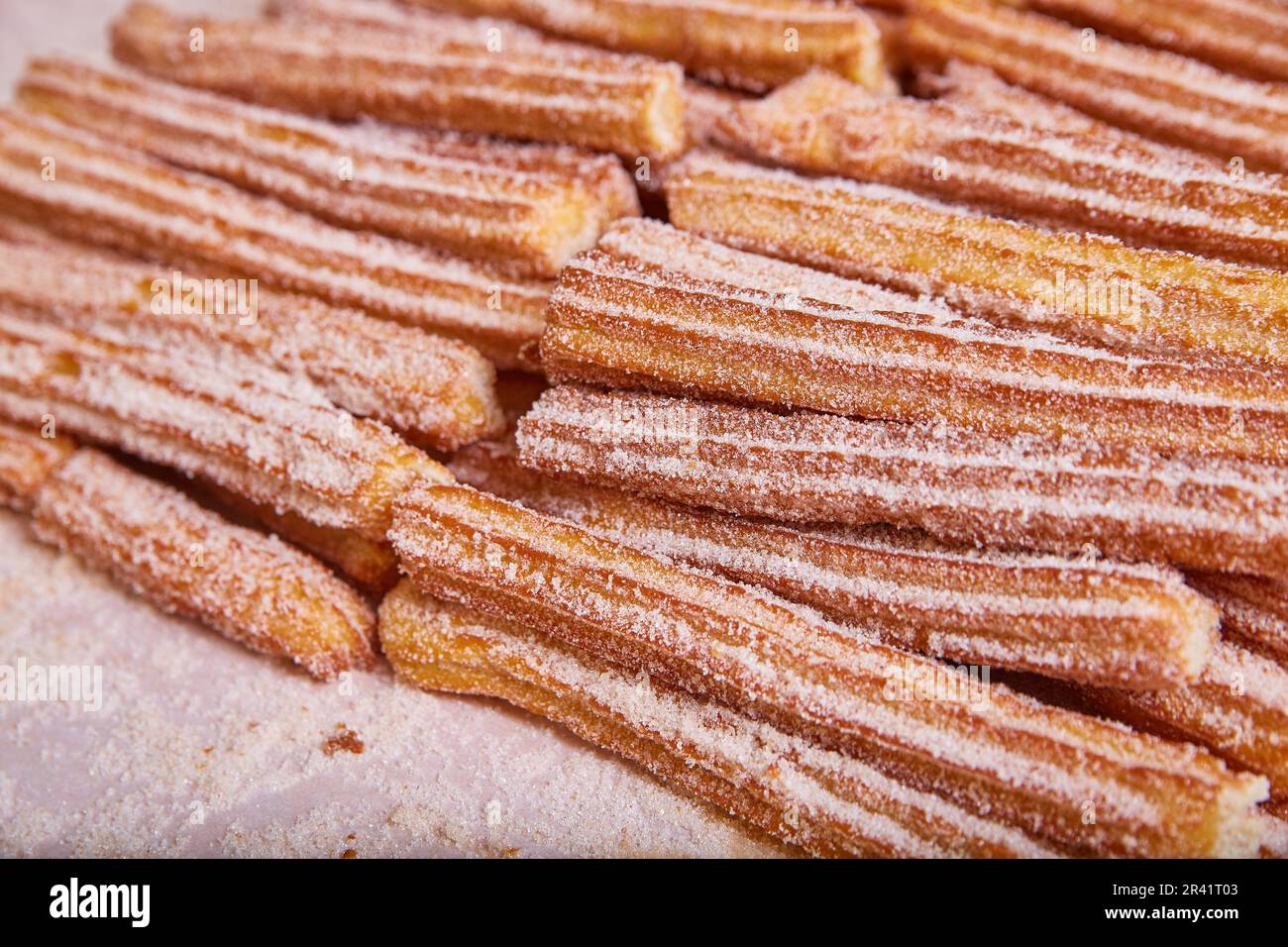 Tray of churros a star-shaped Mexican baked pastry coated in cinnamon ...