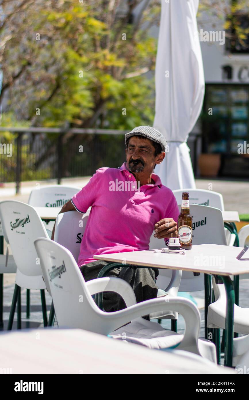 16 April 2023: A local enjoys a San Miguel beer in Torrox town square ...