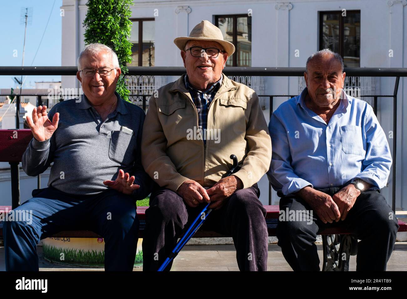 19th April 2023: Three old friends sit together on a public bench in ...