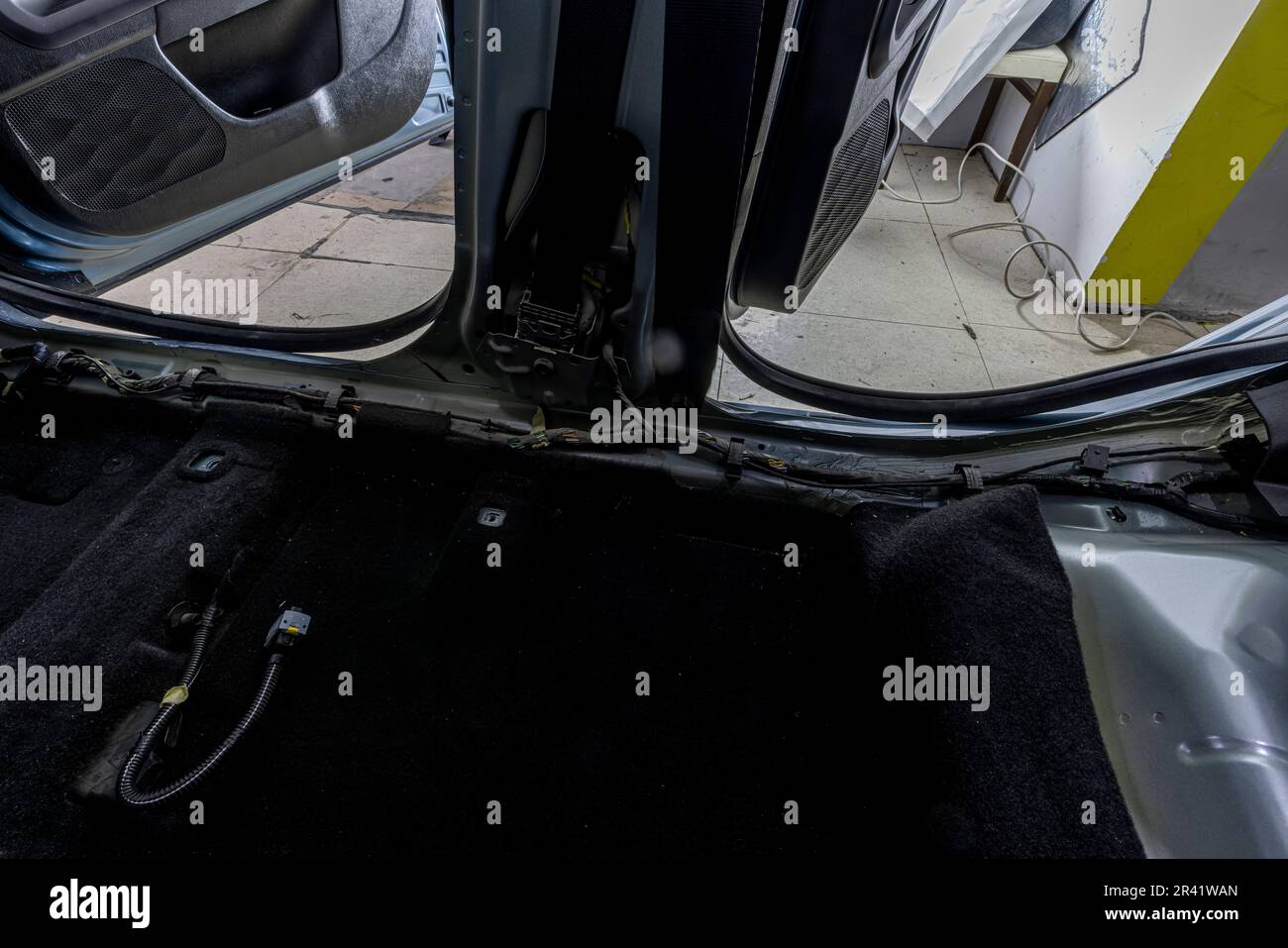 Roll of soundproofing material to car parts. The process of installing ...