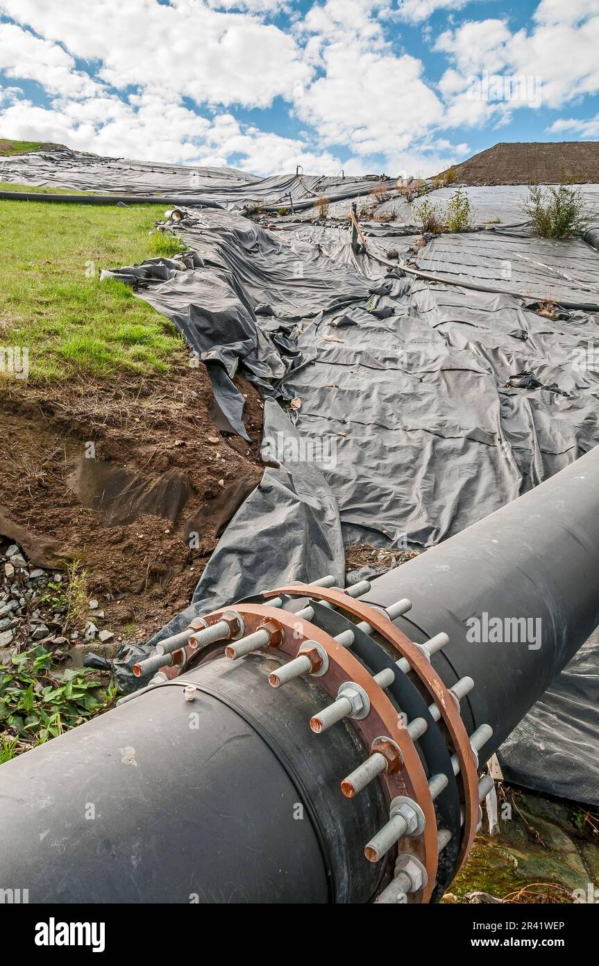Detail shot of a bolted flange joining large pipes that carry methane ...