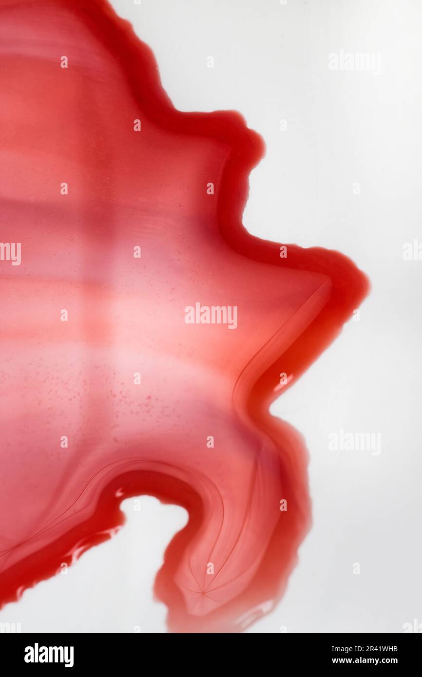 Abstract pool or red blood on vertical white background Stock Photo - Alamy
