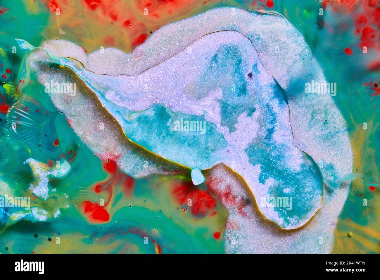 Speckled silver white paint oozes with oil vibrant splashes of color in ...