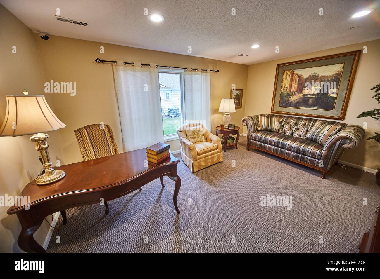 Study den office room fancy with couch, chairs, desk, large painting ...