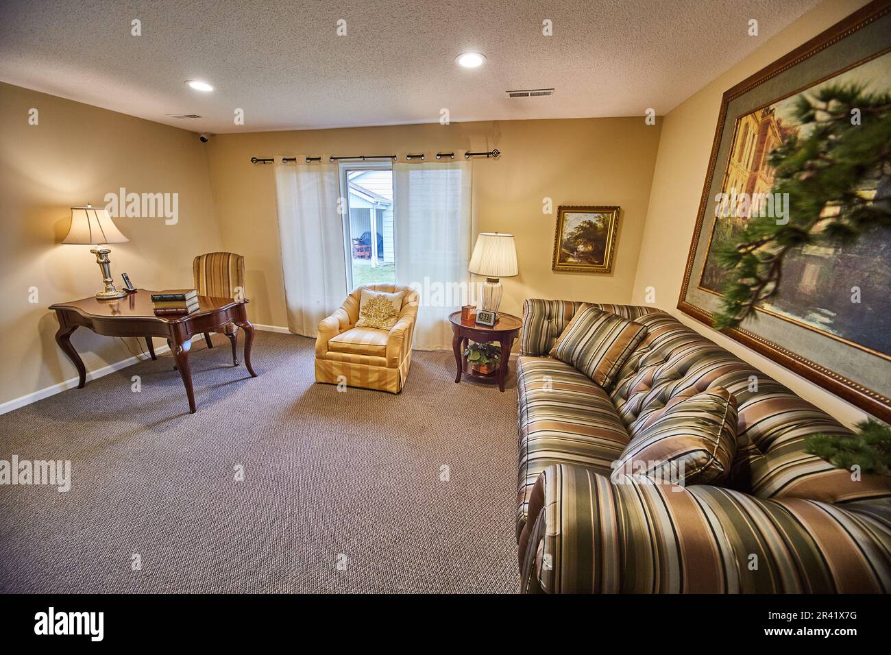 Fancy study den office room with couch, chairs, desk, large painting, camera surveillance and ...