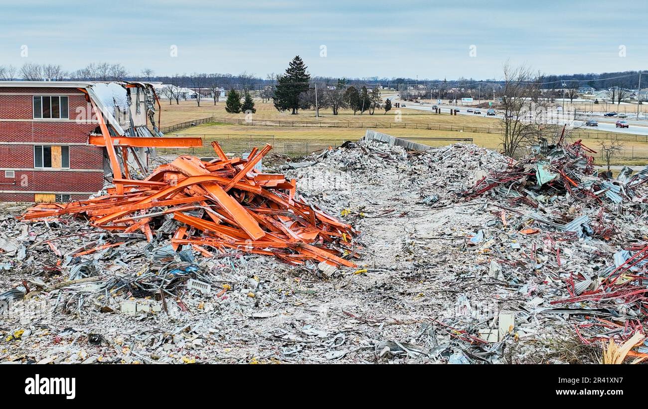 Drone aerial of deconstruction site of abandoned hospital with scrap ...