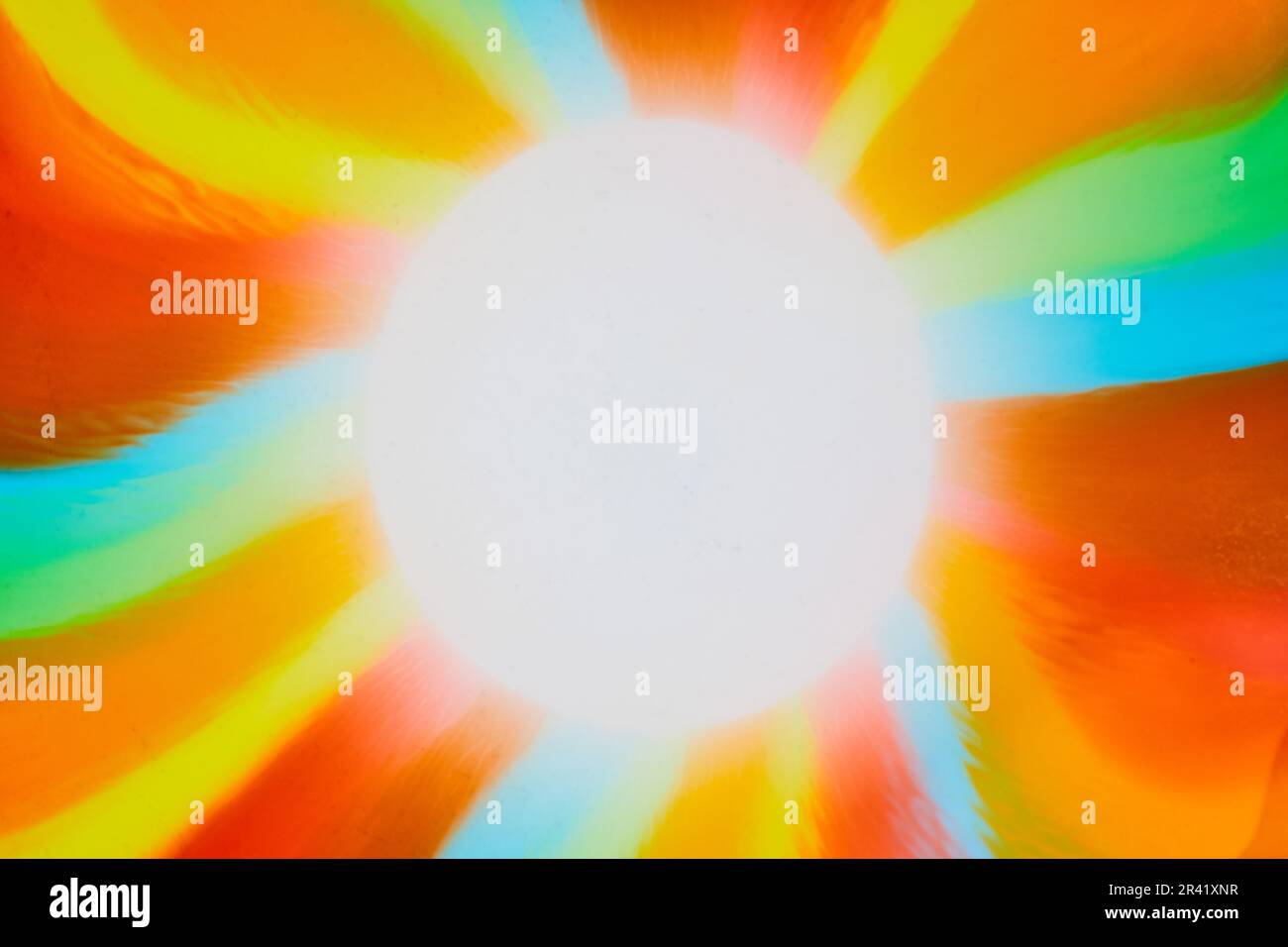 Abstract sun with rays of green and blue and orange and red and yellow ...