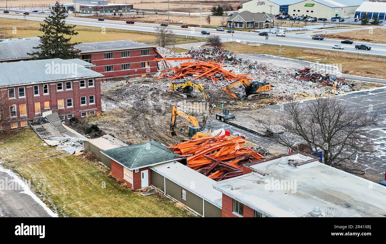 Drone aerial of construction zone as abandoned hospital is ...