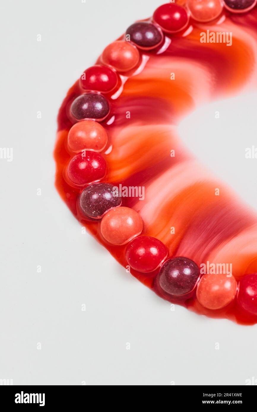 Abstract white background asset with water and sugary skittles candy ...