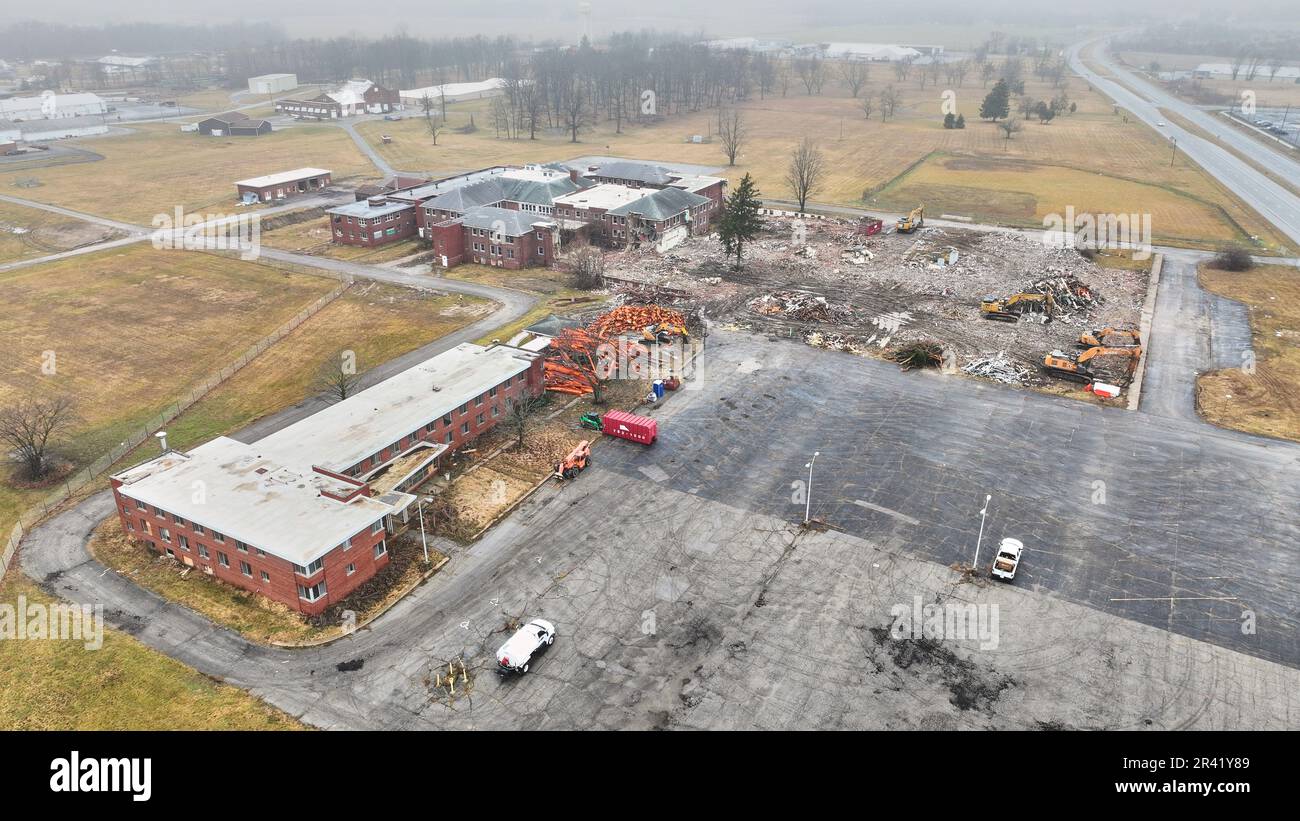 Drone aerial of large construction zone as old abandoned hospital ...