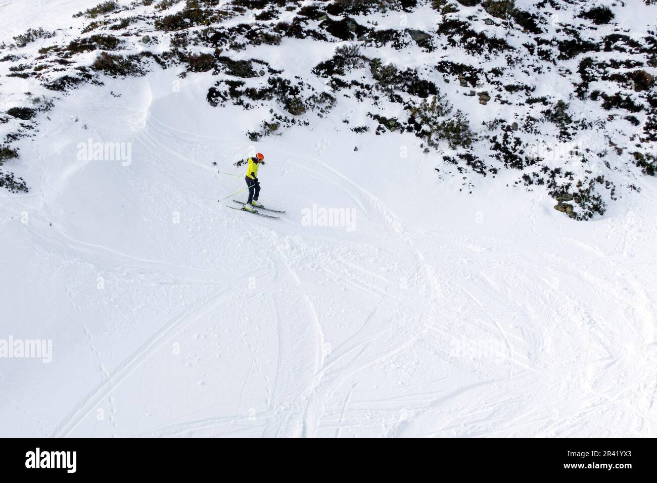 Skier in yellow jacket hi-res stock photography and images - Alamy