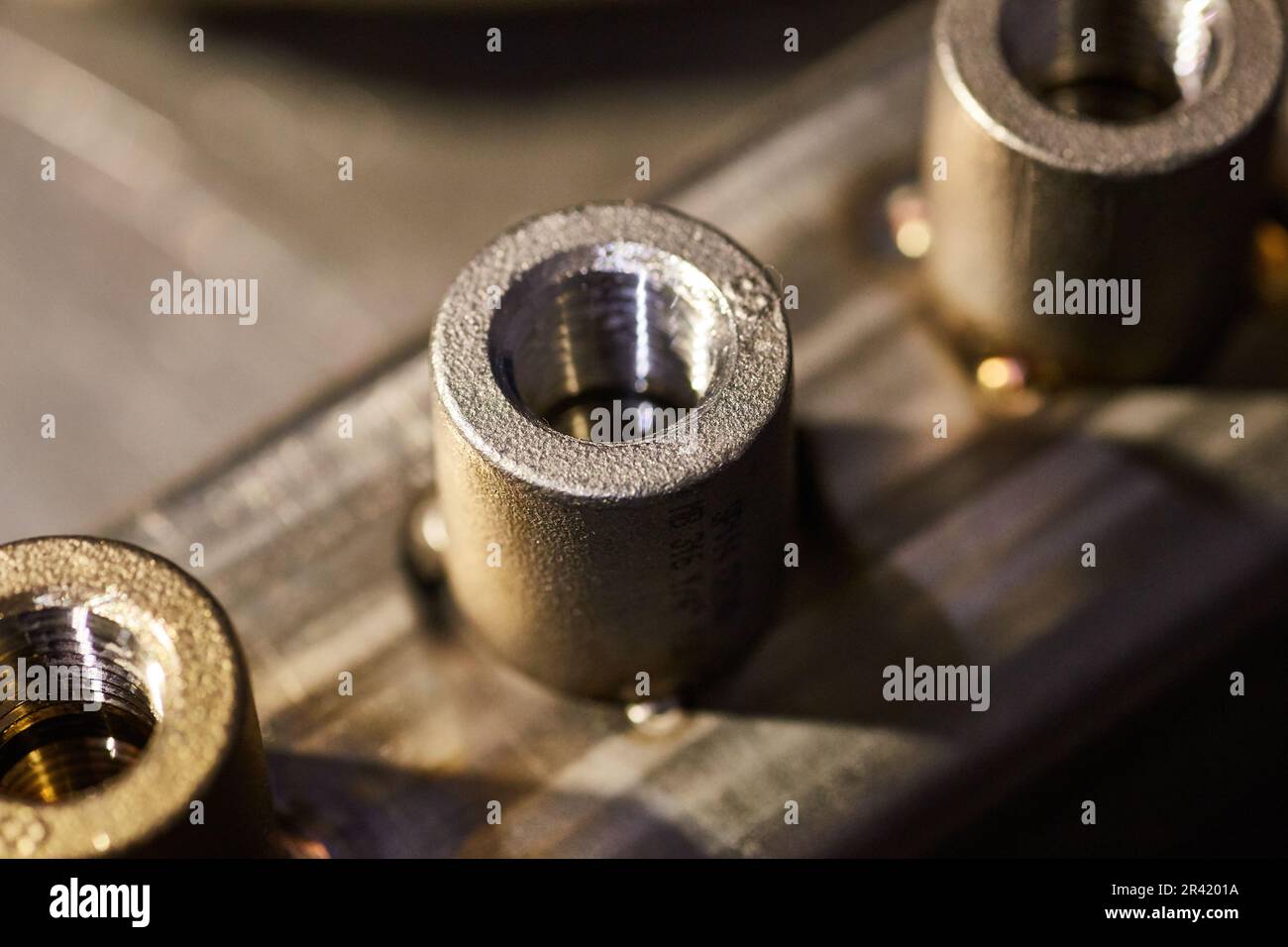 Machinery welding welded round parts on long steel part background ...